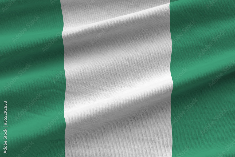 Nigeria flag with big folds waving close up under the studio light ...