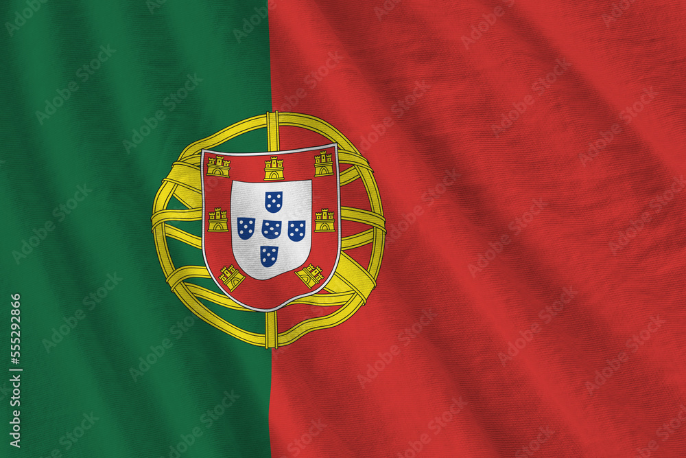 Portugal flag with big folds waving close up under the studio light ...
