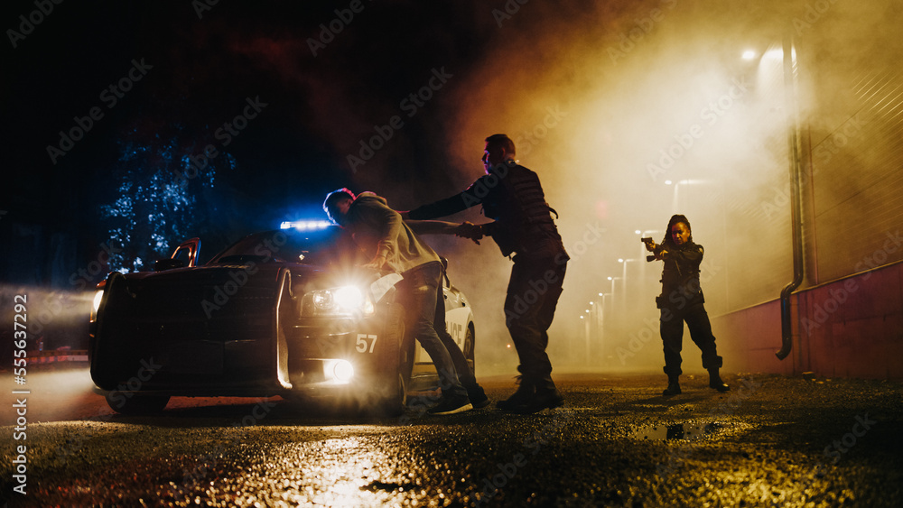 Male Policeman Forcing a Dangerous Criminal on the Hood of Police Car ...
