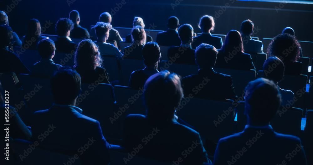 Audience Full of Tech People in Dark Conference Hall Watching an ...