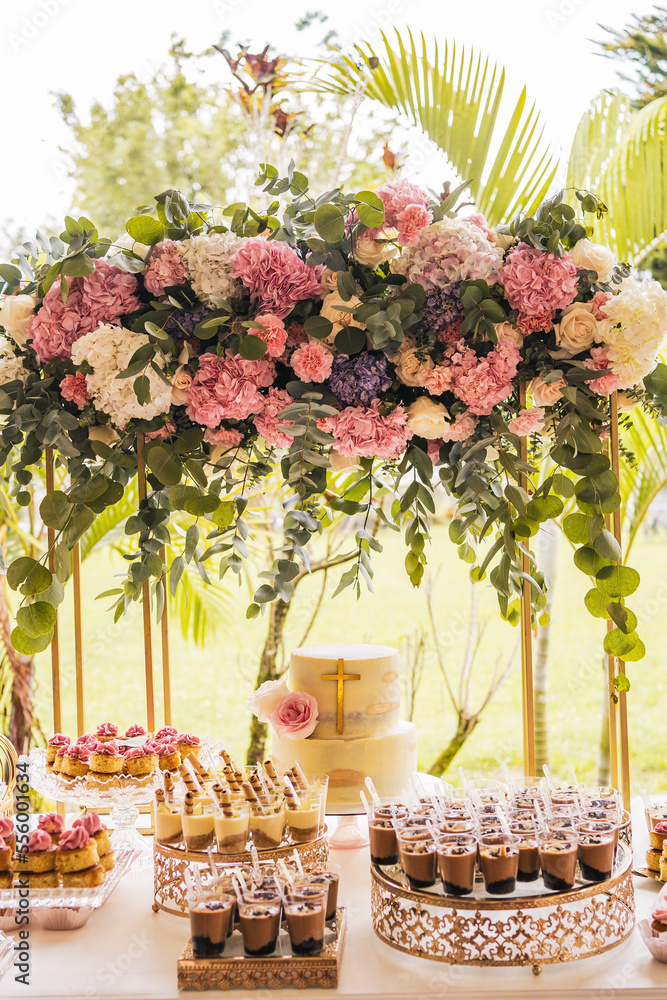 cake for the celebration of a first communion on a table full of ...