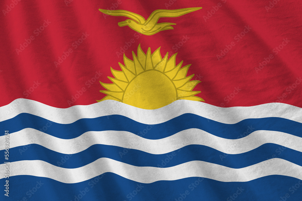 Kiribati flag with big folds waving close up under the studio light ...