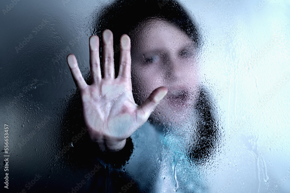 Portrait of young girl with a raised hand making a stop sign gesture ...