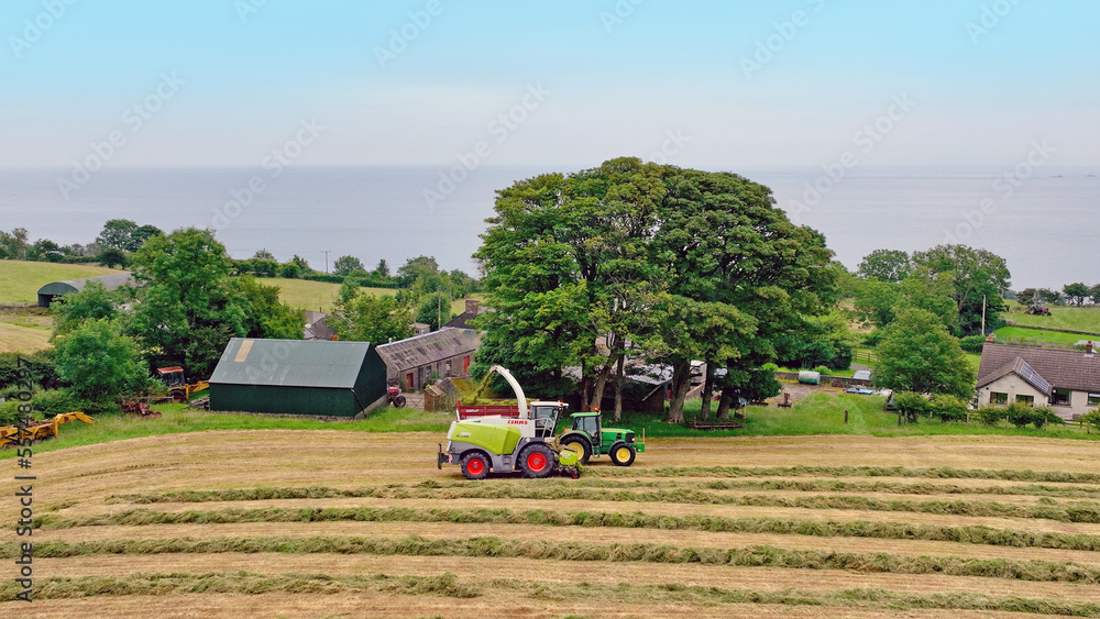 Claas Self Propelled Harvester lifting grass for Silage with a John ...