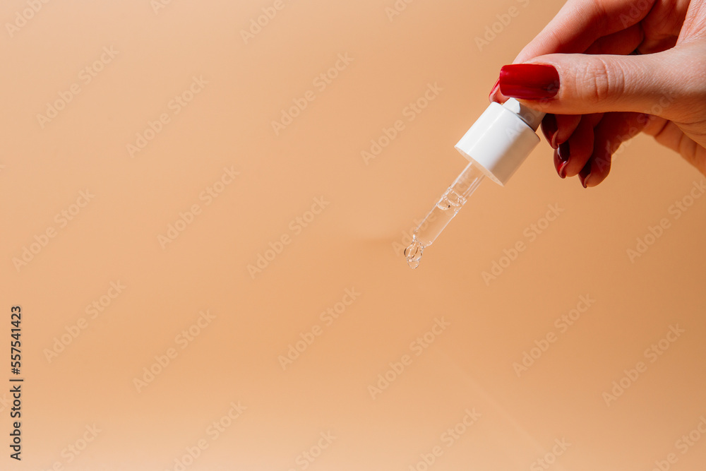 Woman hand holding pipette with collagen moisturizing hyaluron serum ...