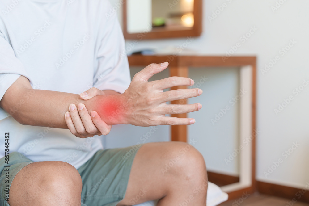 man having wrist pain because using smartphone or computer long time ...