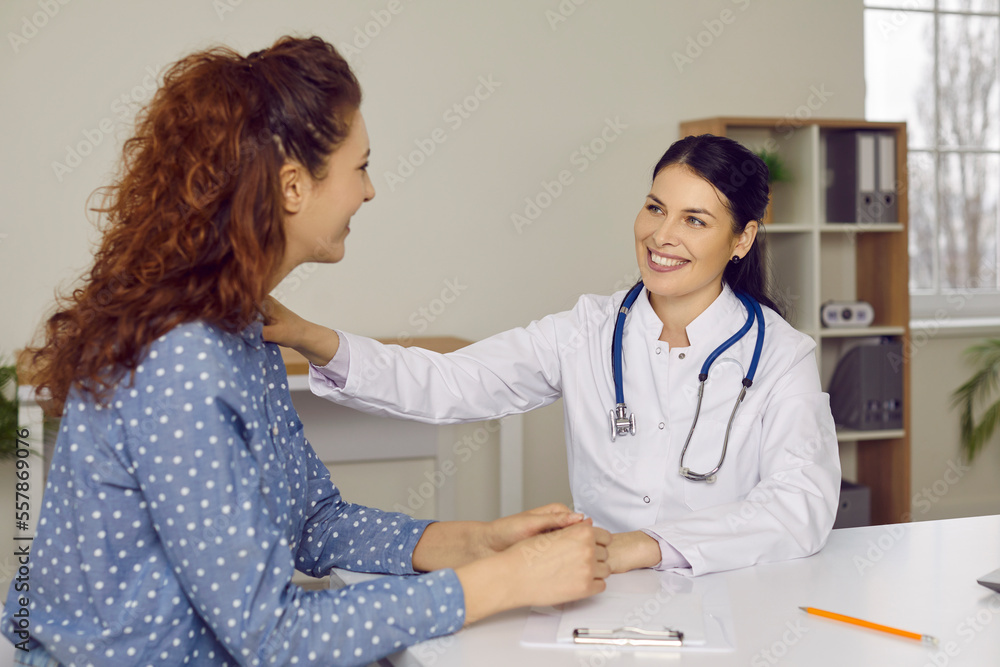 Happy supportive doctor talking to patient. Cheerful friendly doctor in ...