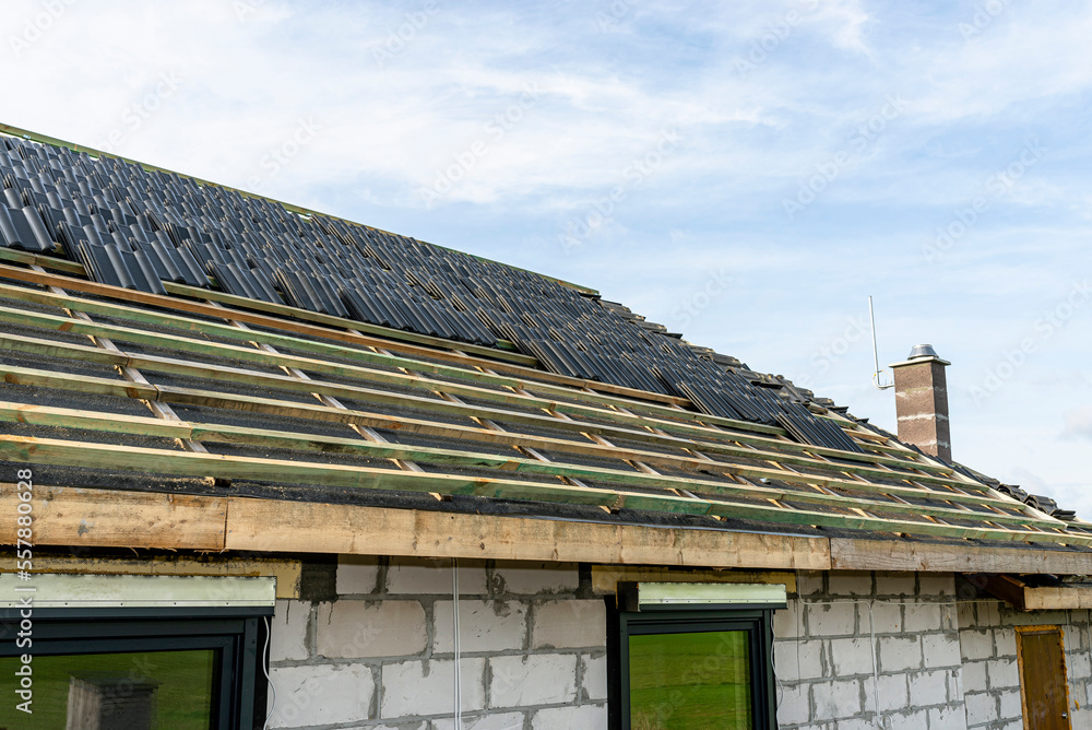 Roof ceramic tile arranged in packets on the roof on roof battens ...
