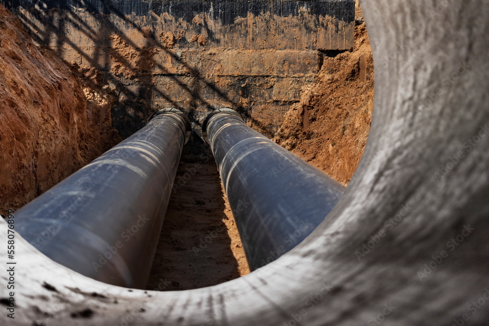 Foto de Stock Laying of underground pipes in concrete chamber ...