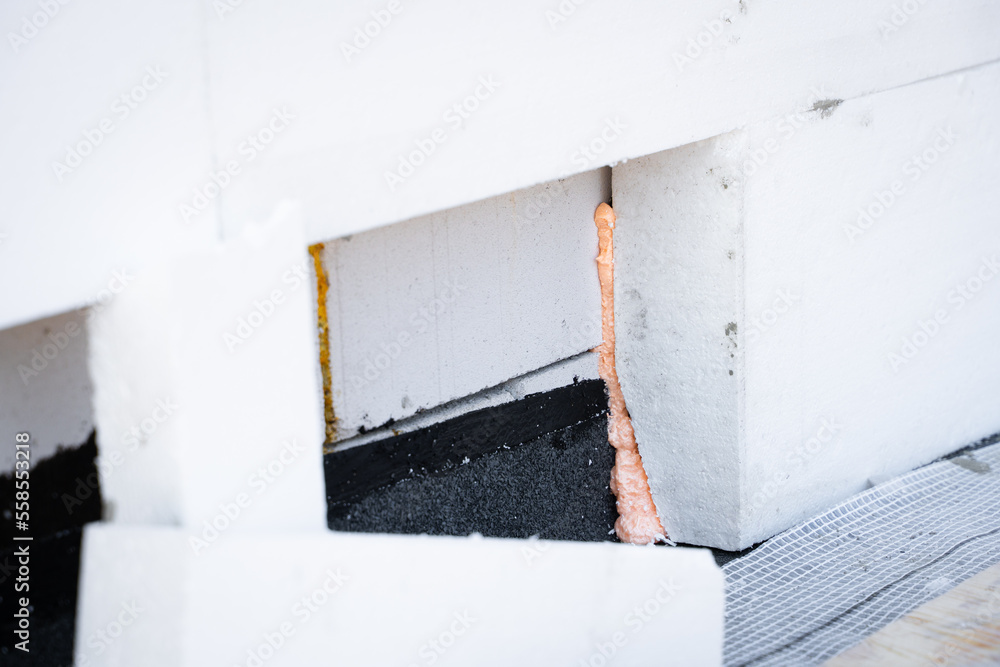 The process of insulating a house with polystyrene foam insulation. A ...