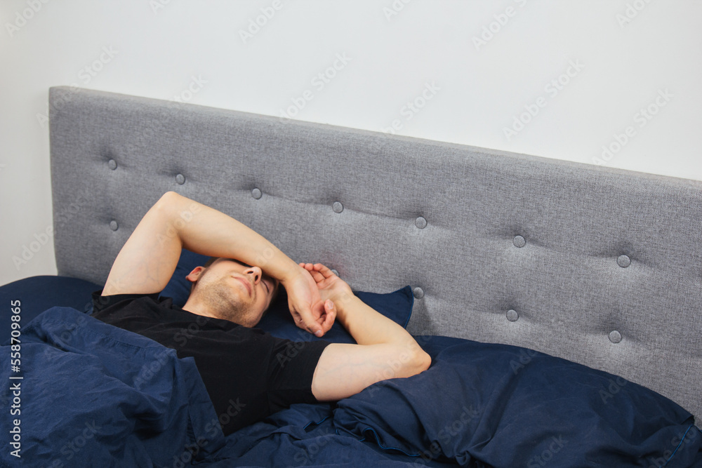 Top view of a handsome young man sleeping comfortably on the bed at ...
