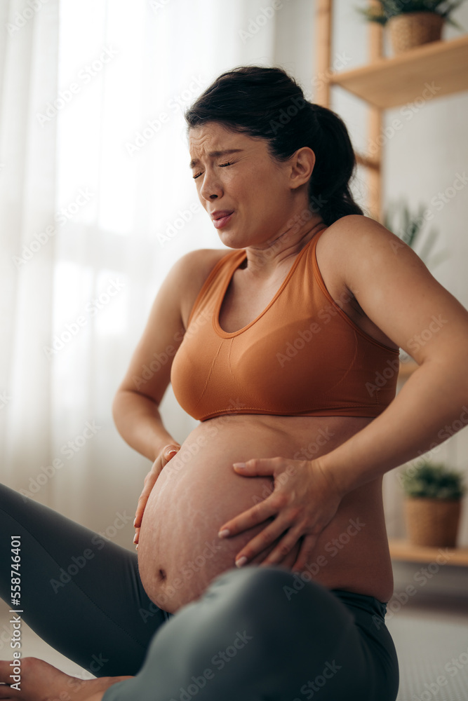 Pregnant woman in outstanding pains is feeling contractions and waiting ...