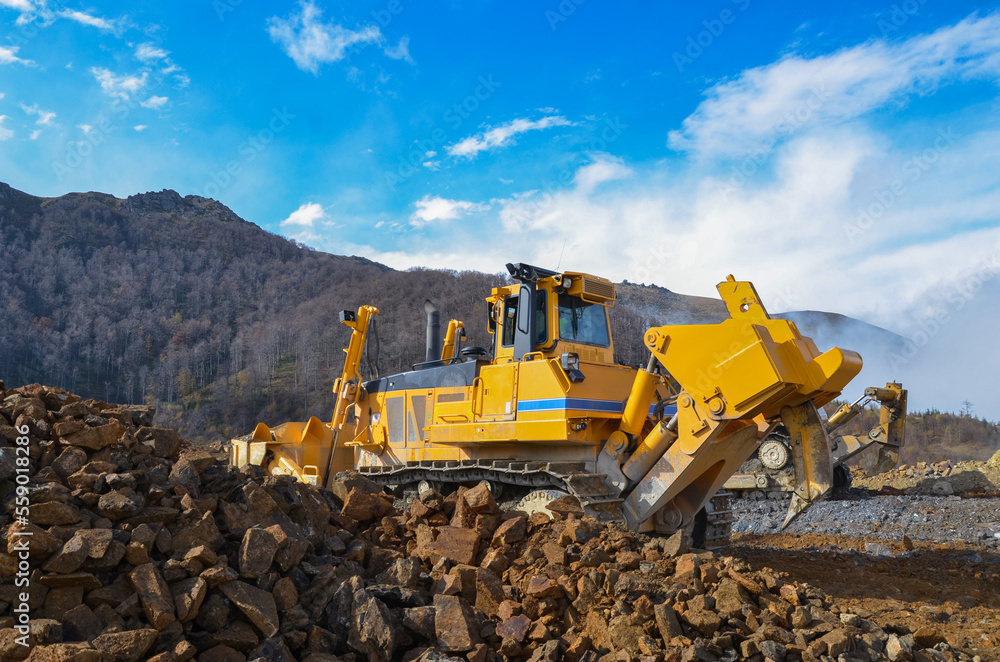 Big crawler dozer working on construction site or quarry. Mining ...