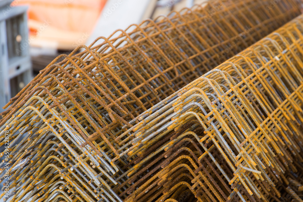Structural steel with some rust stored on a construction site for later ...