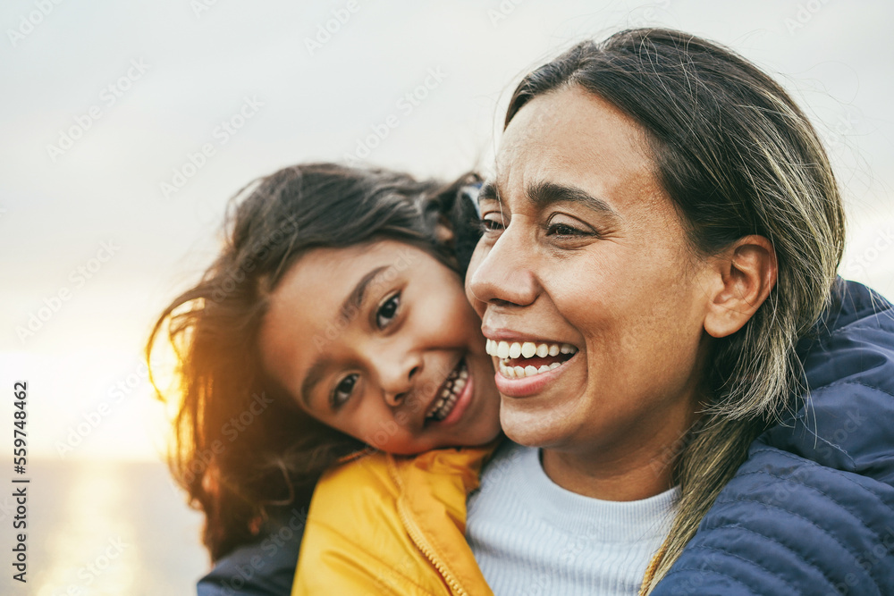 Happy latin mother and daughter having fun during winter time - Mom day ...