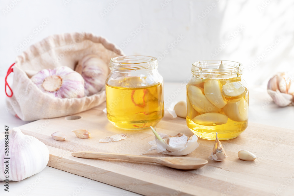 Fermented garlic cloves in a jar of honey. Healthy food and medicine ...