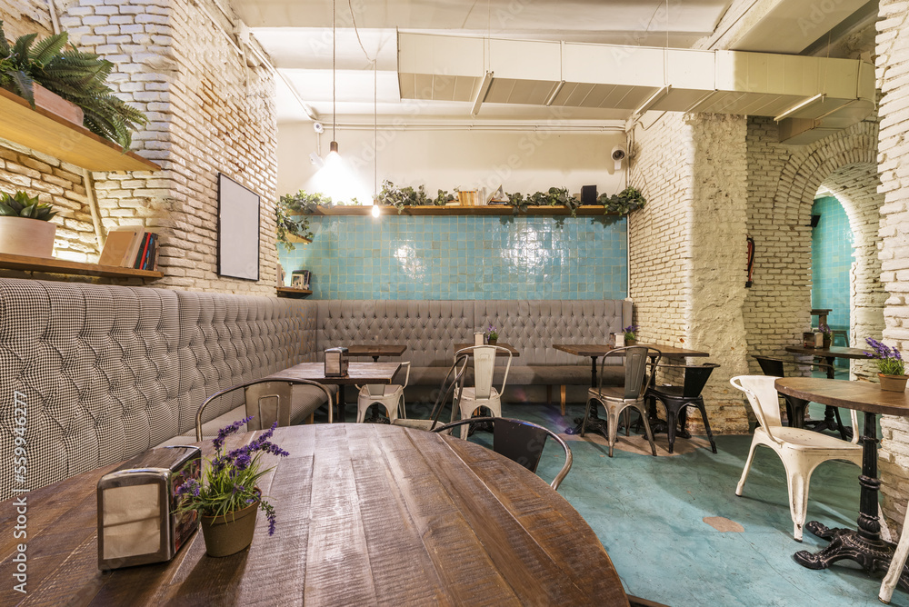 Living room of a restaurant with a sofa running along the entire ...