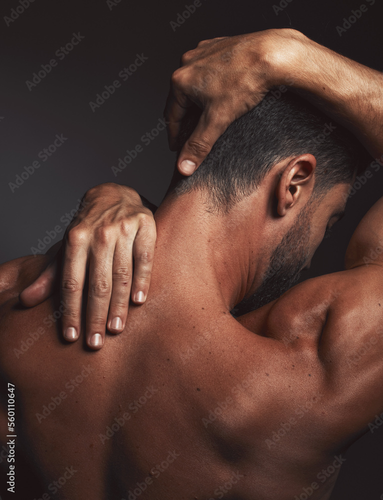 Stretching, fit man and back muscle on dark black studio background ...