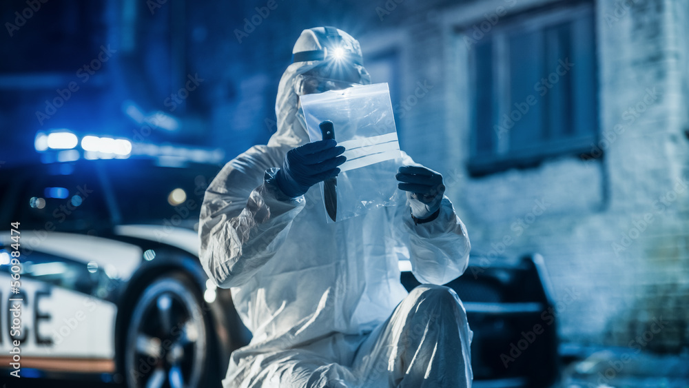 Forensics Specialist at a Crime Scene, Putting Murder Weapon in ...