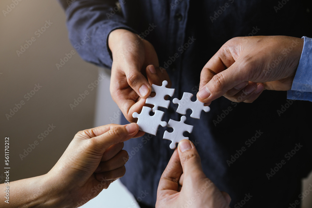 Business people with jigsaw puzzle pieces in office, Successful ...
