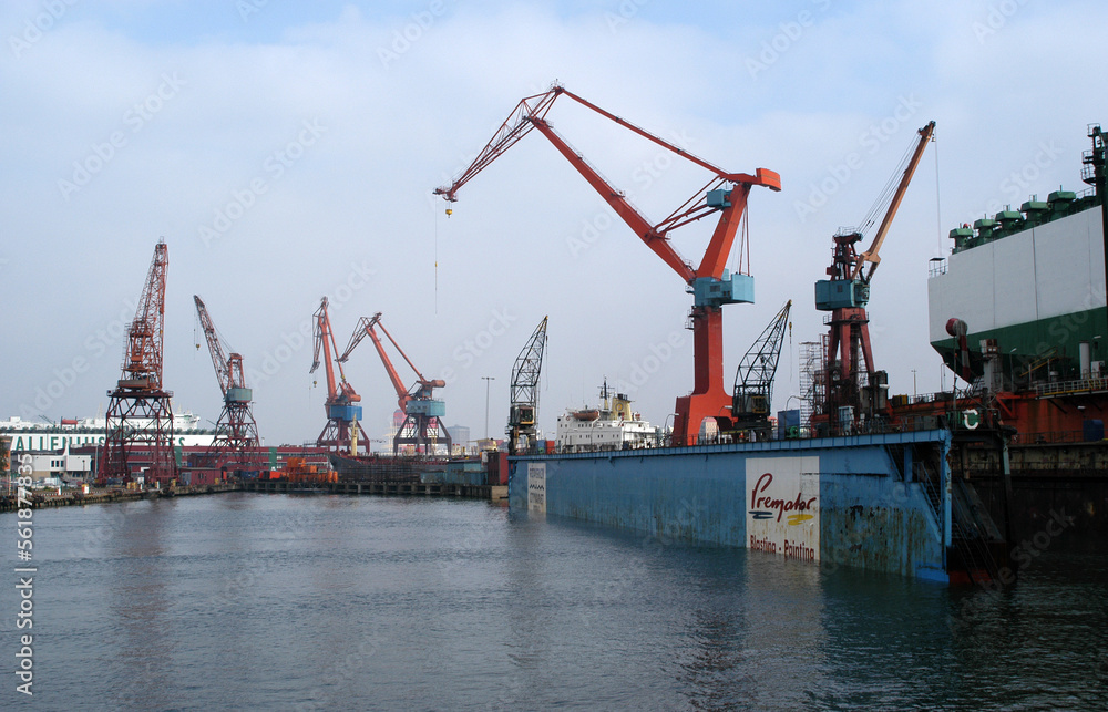 The port at Gothenburg, Sweden with cranes and a ship in dry dock ready ...