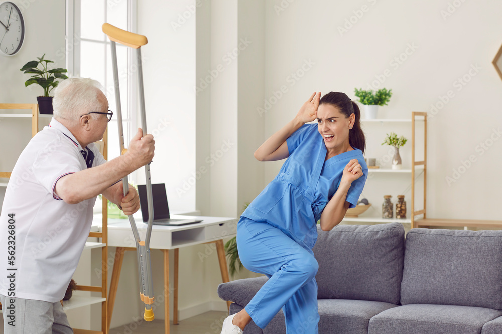 Angry aggressive elderly man threatening to his caregiver woman ...