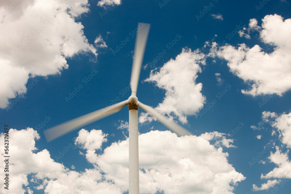 A lone wind turbine stands defiant pointing to a more sustainable ...