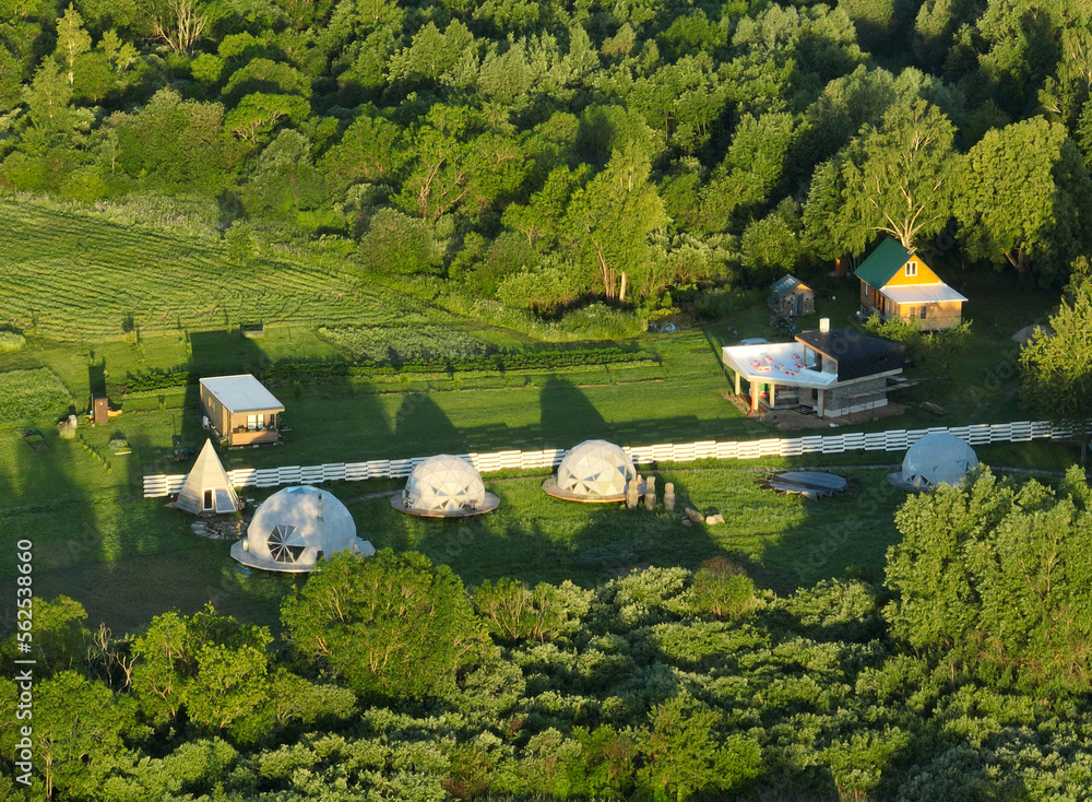 Glamping house and house in village. Spherical house in country, drone ...