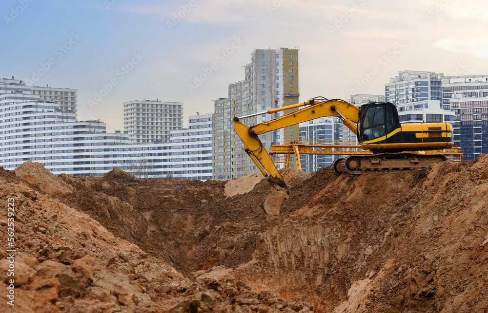 Foto Excavator dig the trenches at a construction site. Trench for ...