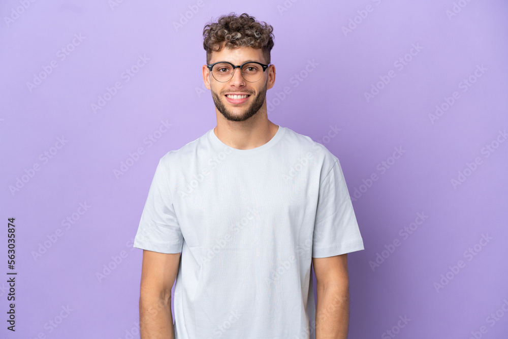 Delivery caucasian man isolated on purple background laughing の Stock ...