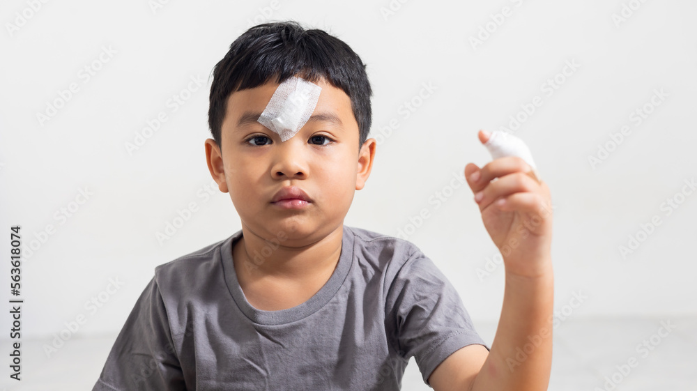 Asian boy is sad He had wound on face and fingers. Asian kid boy was ...