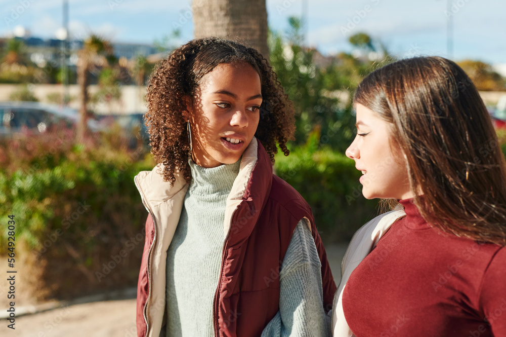 Smiling teens talking outdoors Stock Photo | Adobe Stock