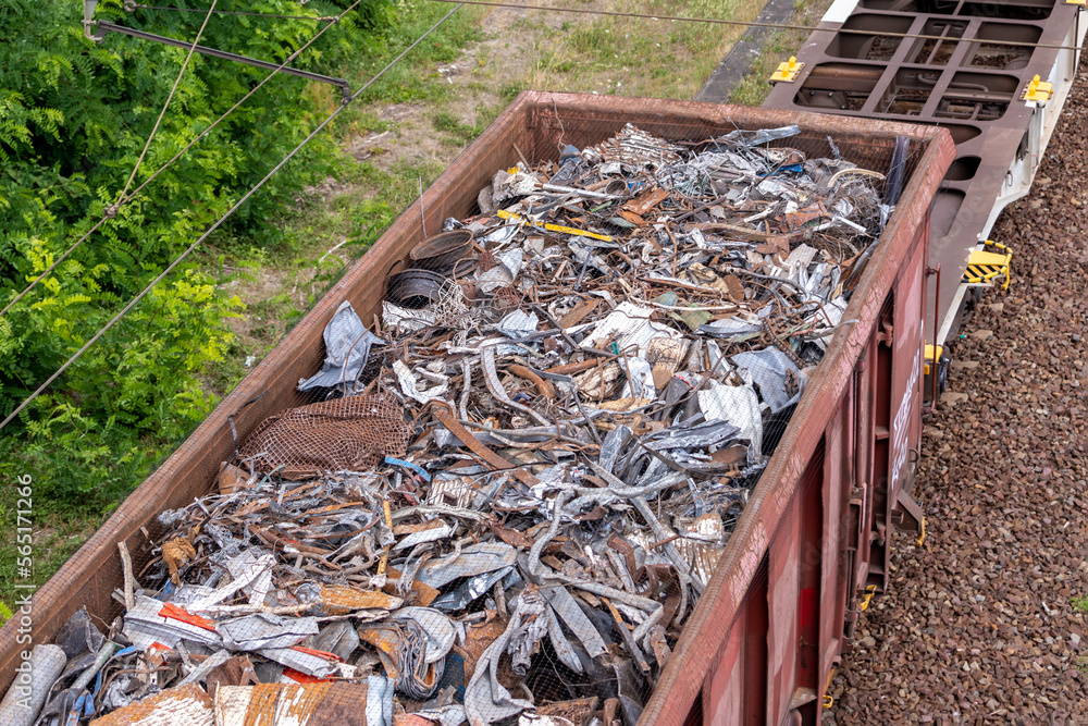 Above view of railway cargo train wagon filled by old rusty black metal ...