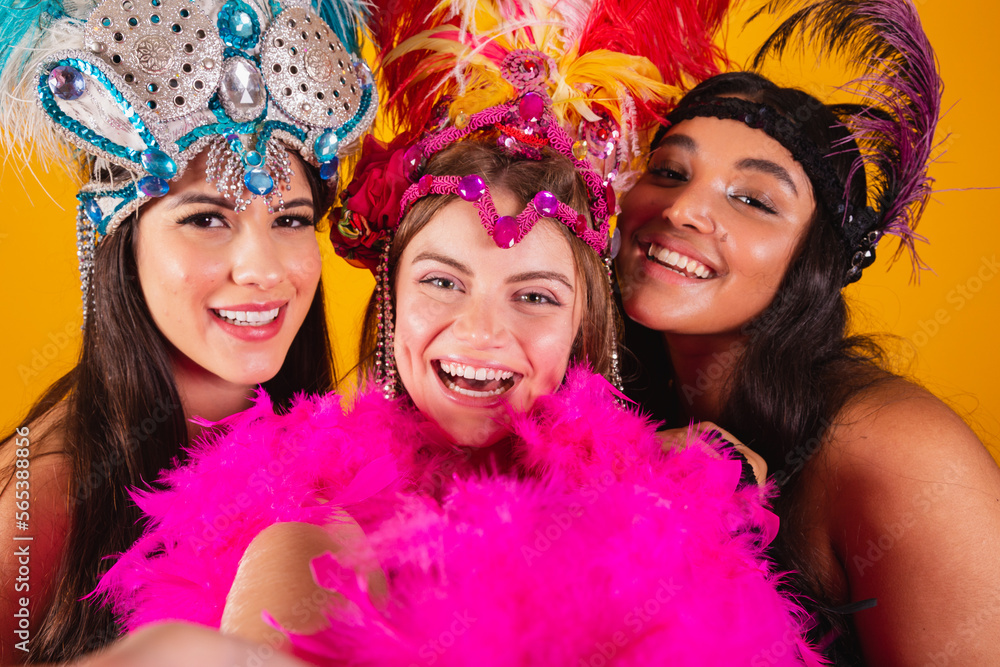 three brazilian female friends with queen clothes from samba school ...