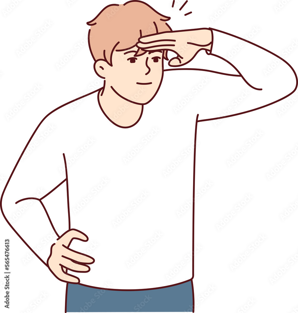 Young man raises hand to forehead to see distant object or protect eyes ...