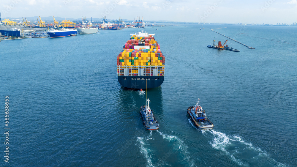 Tub Boat with Stern of cargo ship carrying container and running for ...