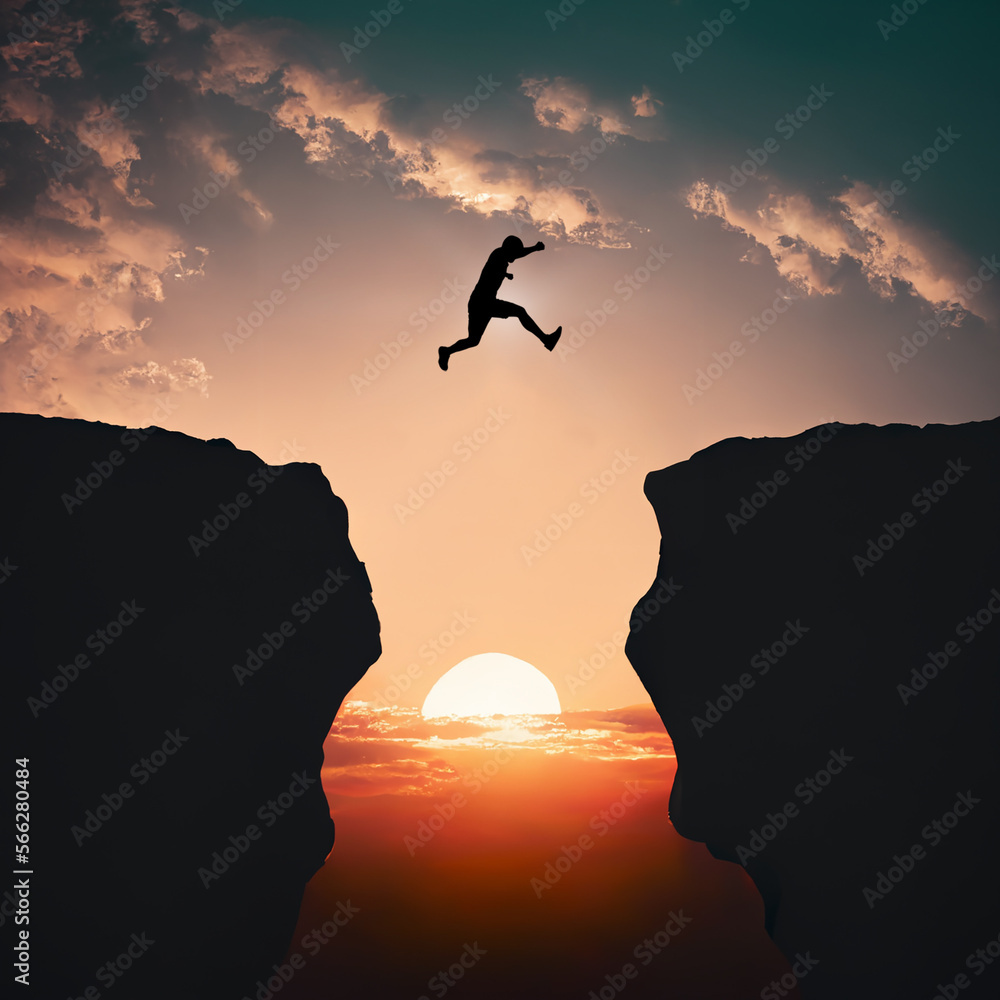 silhouette of businessman jumping over the cliff on sunset background ...
