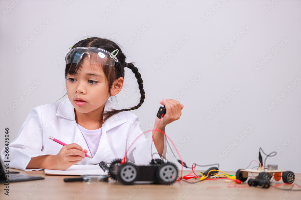 Asian little girl students learn at home by coding robot cars in STEM ...