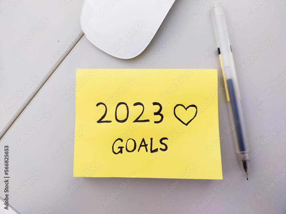 writing 2023 new year resolution goal on yellow sticky note with love ...