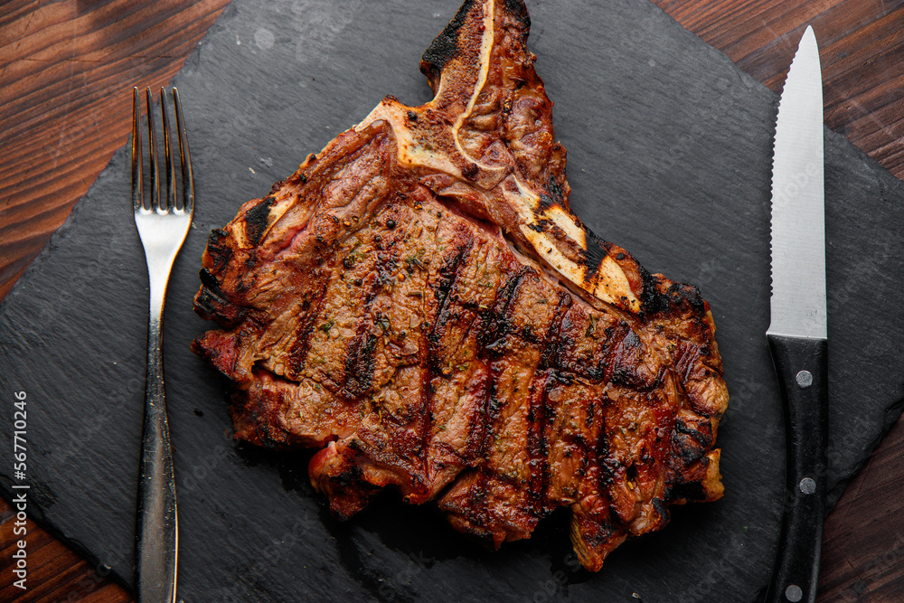 top view of delicious ribeye beef steak on the ribbon on the black ...