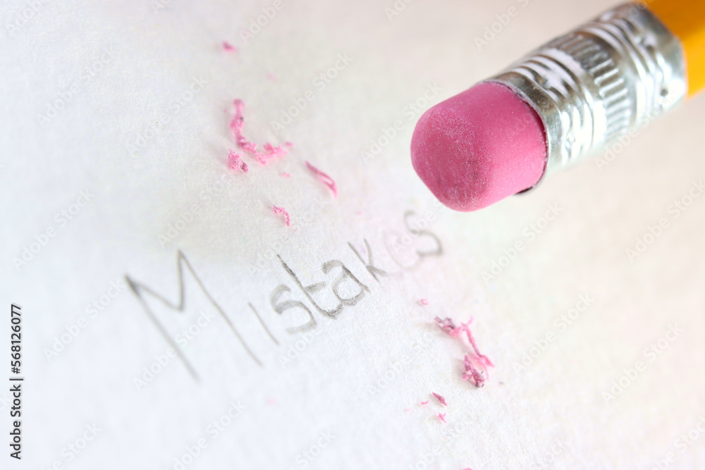 Written word mistake on textured paper, with some letters partially ...