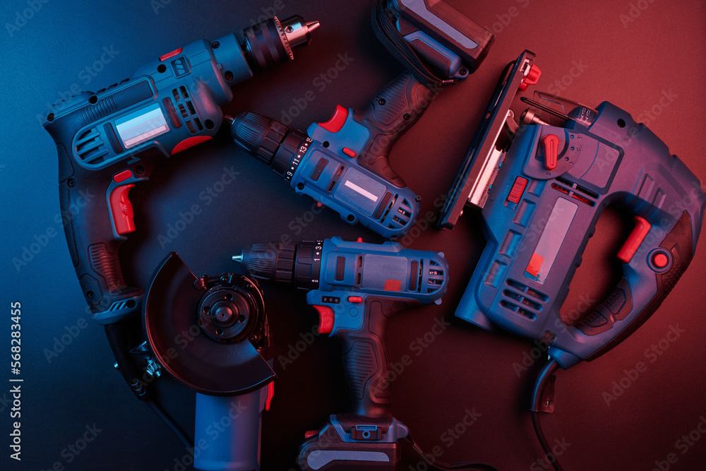 Set of new power tools isolated on a black background, drill, puncher ...