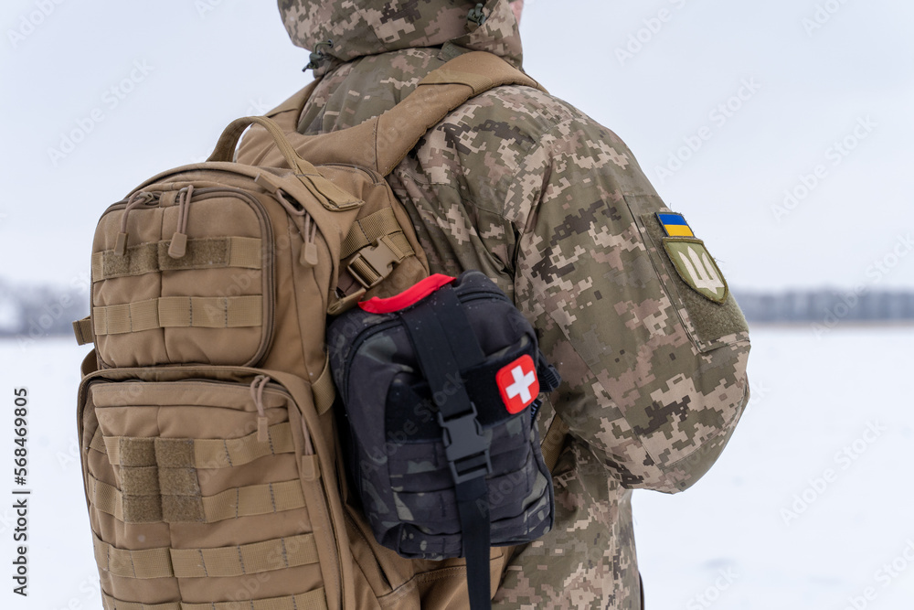 Ukrainian military man in winter uniform with tactical backpack and ...