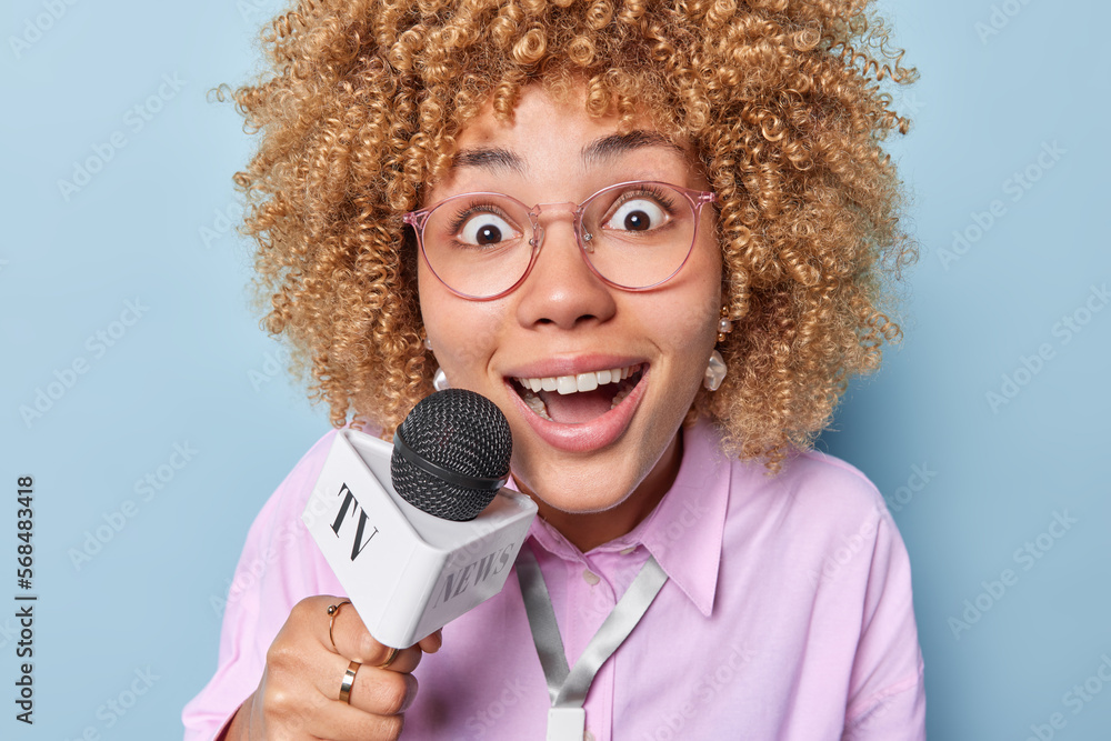Foto de Stock Photo of surprised female TV presenter looks with happy ...