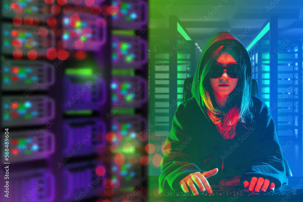 Stock-Foto „Woman hacker. Girl is typing on keyboard. Hooded woman is hacking servers. Young ...