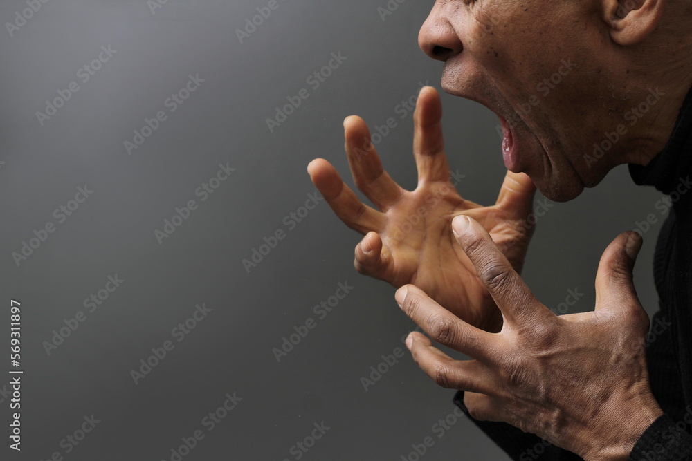 man screaming and shouting with anger on grey background with people ...