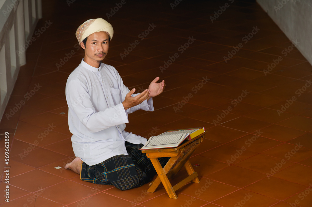 Religious muslim islam man in white session sit on the floor and read ...