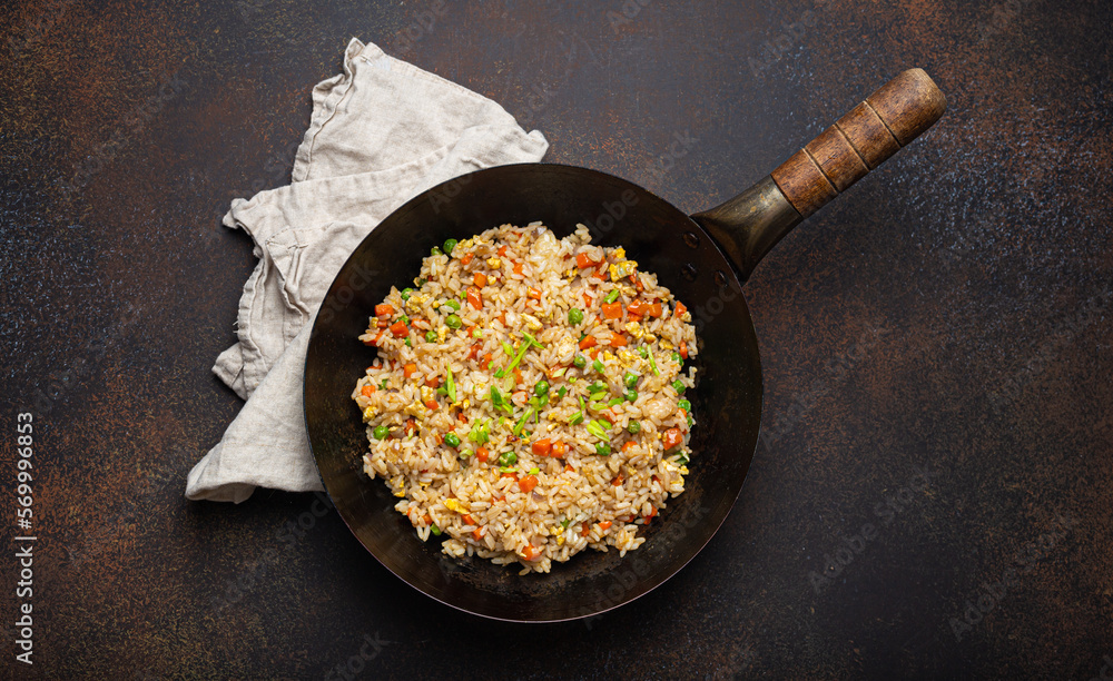 Authentic Chinese and Asian fried rice with egg and vegetables in wok ...
