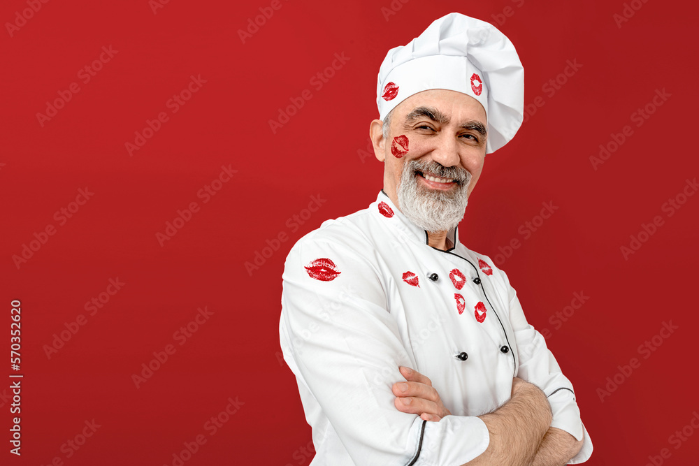 Chef-cooker in a chef's hat and jacket with lipstick marks on face skin ...