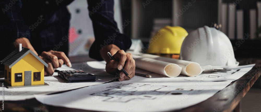 Image of engineer drawing a blue print design building or house, An ...